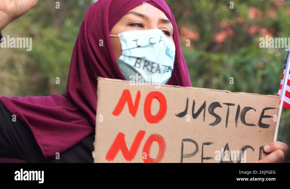 Arab immigrant Muslim woman in a hijab supports the movement Black ...