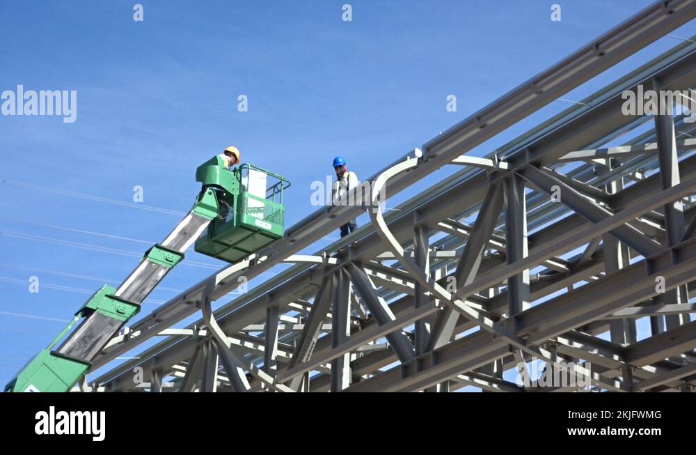 Construction workers working at height installing the steel structure ...