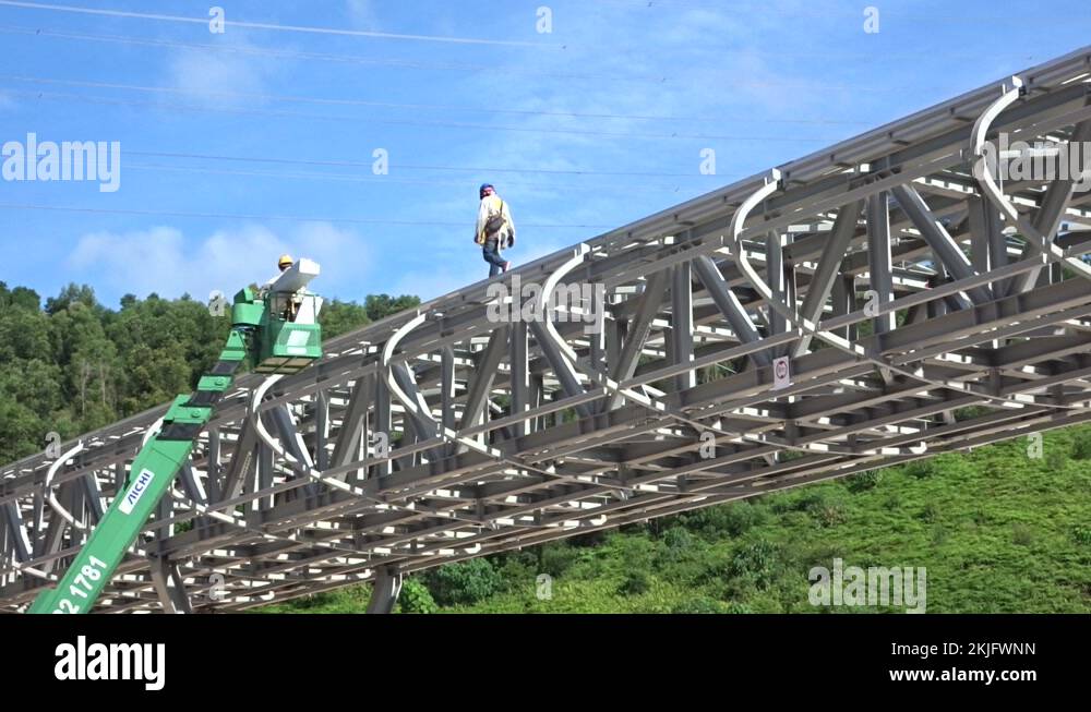 Construction workers working at height installing the steel structure ...