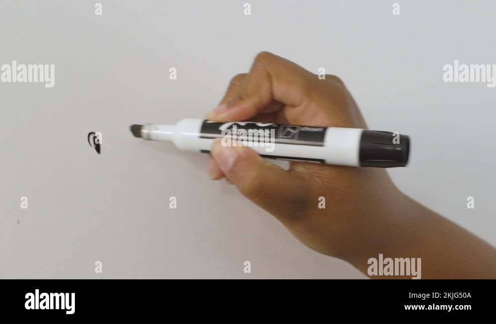 Drawing a target on a whiteboard in an office with a marker. Close up ...