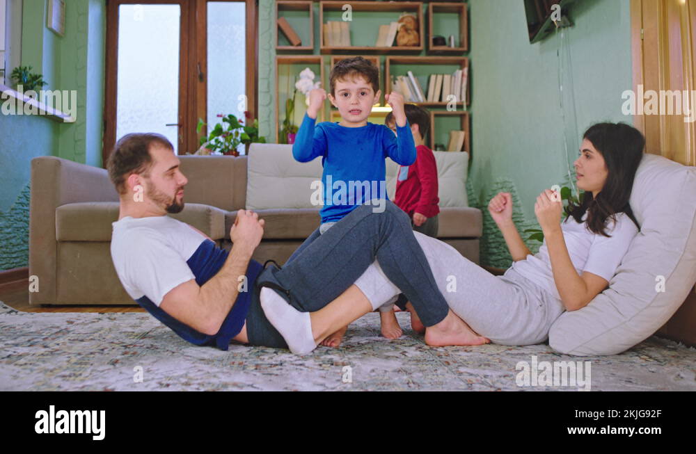 Happy family spending the day all together with kids mom and dad laying ...