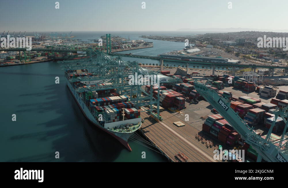 Container cranes operating in port on lifting containers from a ship ...