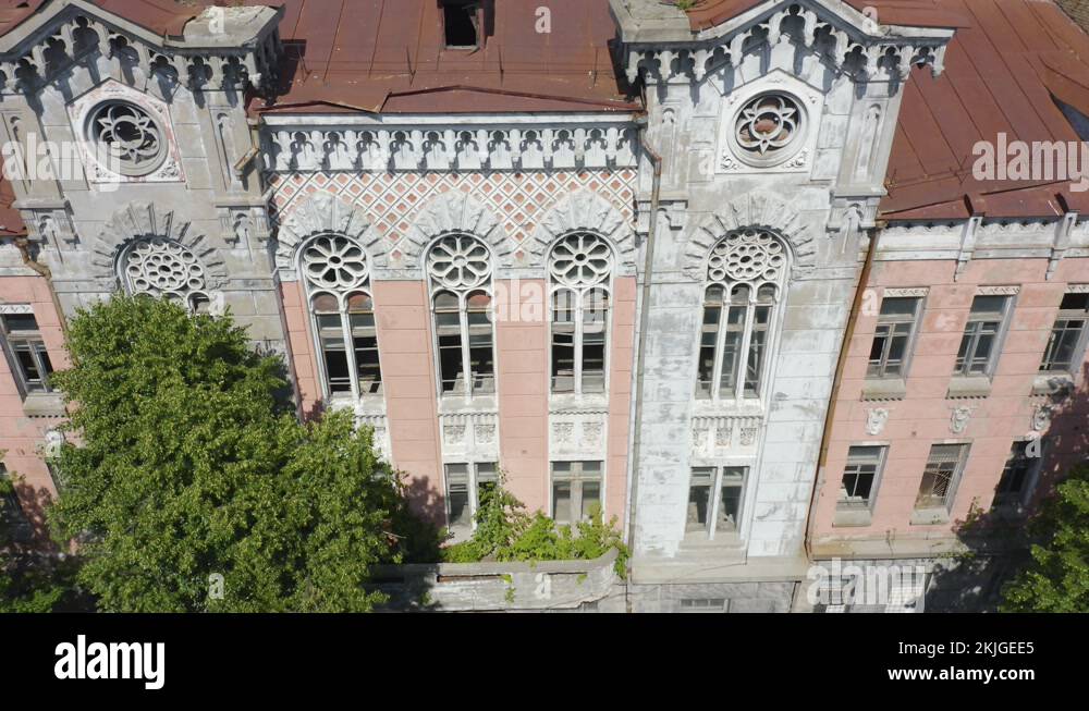Abandoned building in Venetian Gothic style with broken arched windows ...