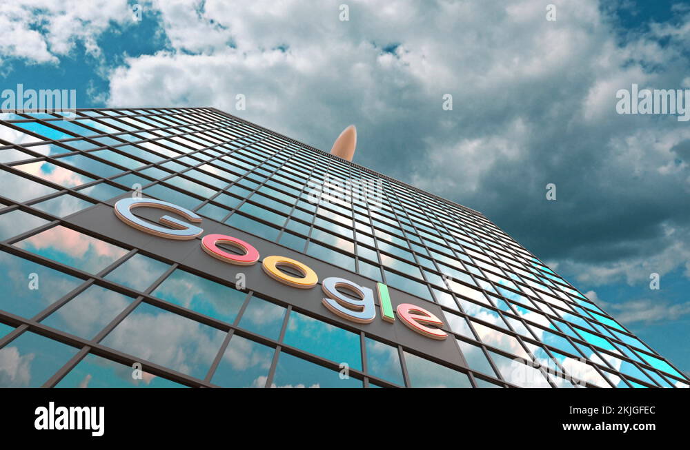 Google logo on a modern skyscraper reflecting clouds and flying ...
