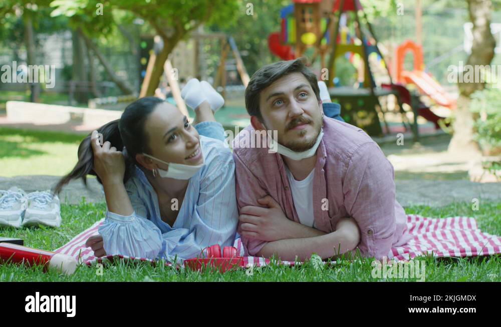 Two young people are looking somewhere in the distance, embracing each ...