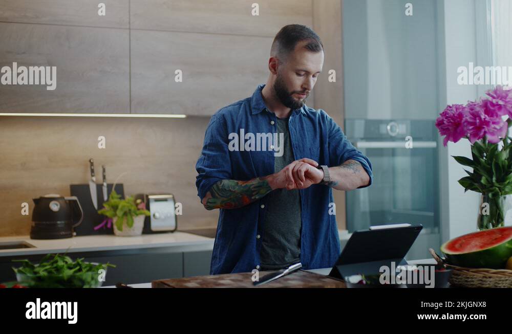 Handsome Male Looks on His Watch and Notes Time How Long He Will Be ...