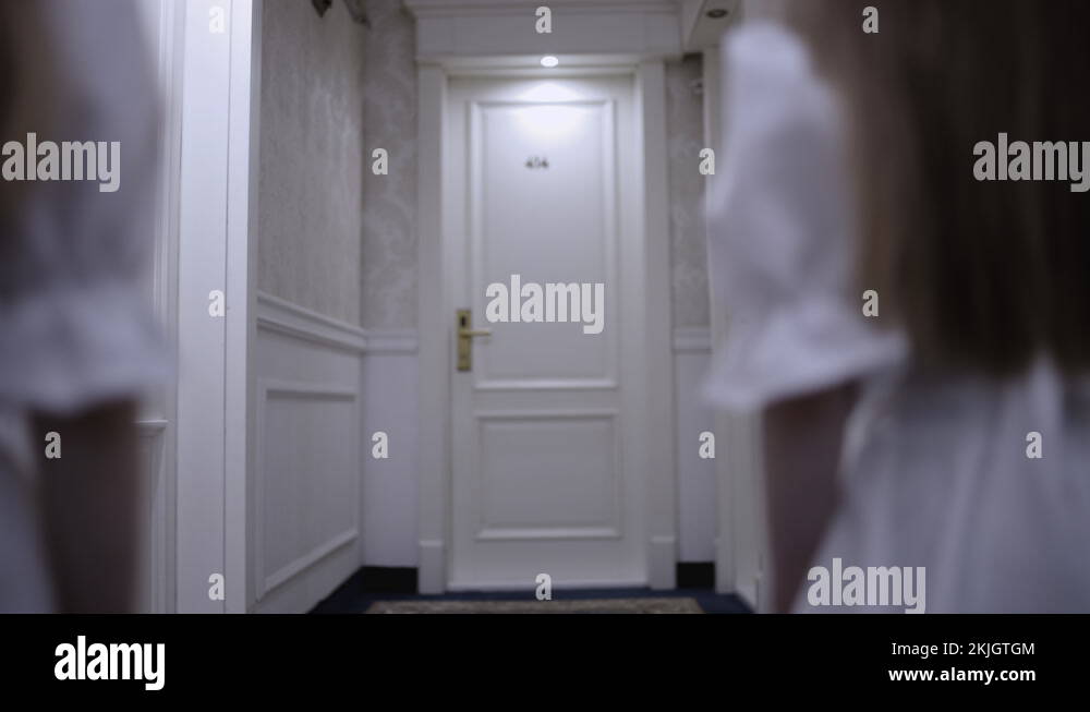 Two little girls wandering spooky haunted house back view, terrible ...