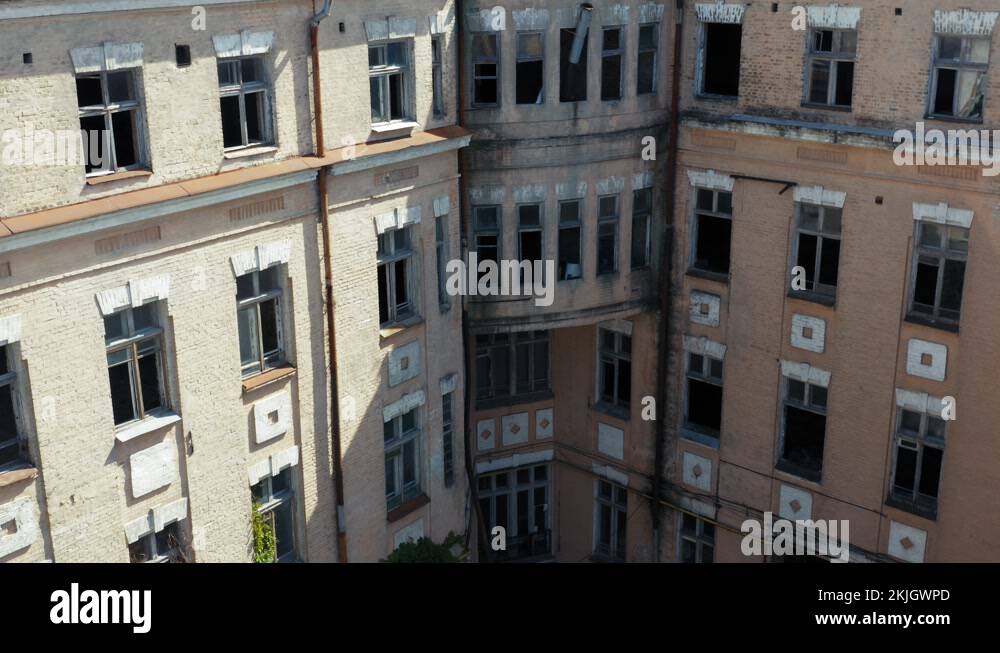 Abandoned old hospital building with a broken windows. Aerial side view ...
