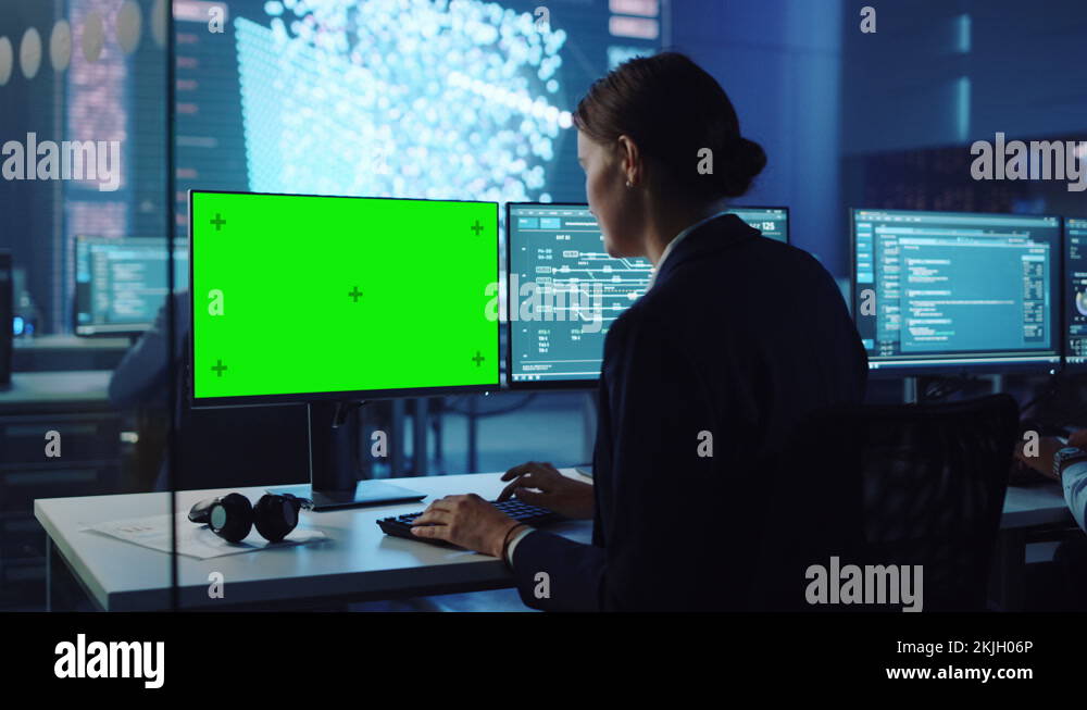 Female Computer Data Science Engineer Works on a Computer with Green ...
