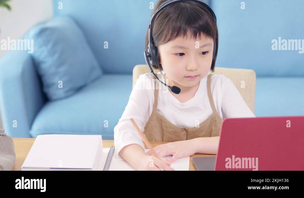 Asian little girl taking an online class. e-learning. EdTech Stock ...