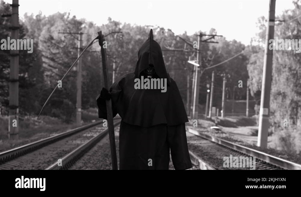 Grim Reaper with Scythe Walking on Railway Tracks Stock Video Footage ...