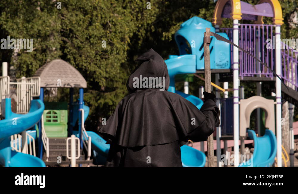 Grim Reaper with Scythe Walking Along Playground Stock Video Footage ...
