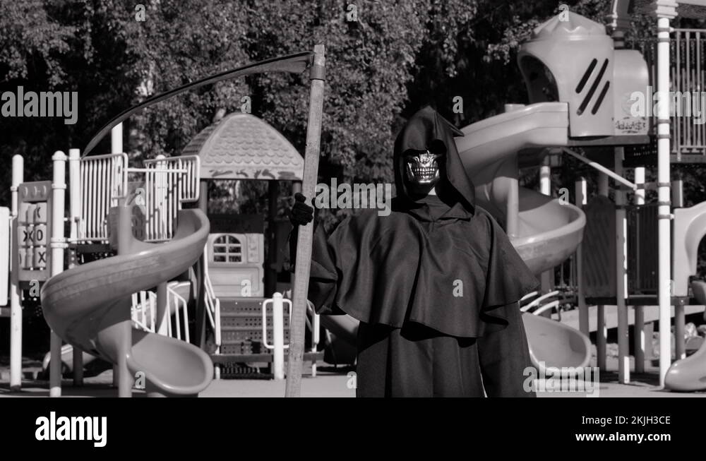 Scary Grim Reaper Walking on a Playground Stock Video Footage - Alamy