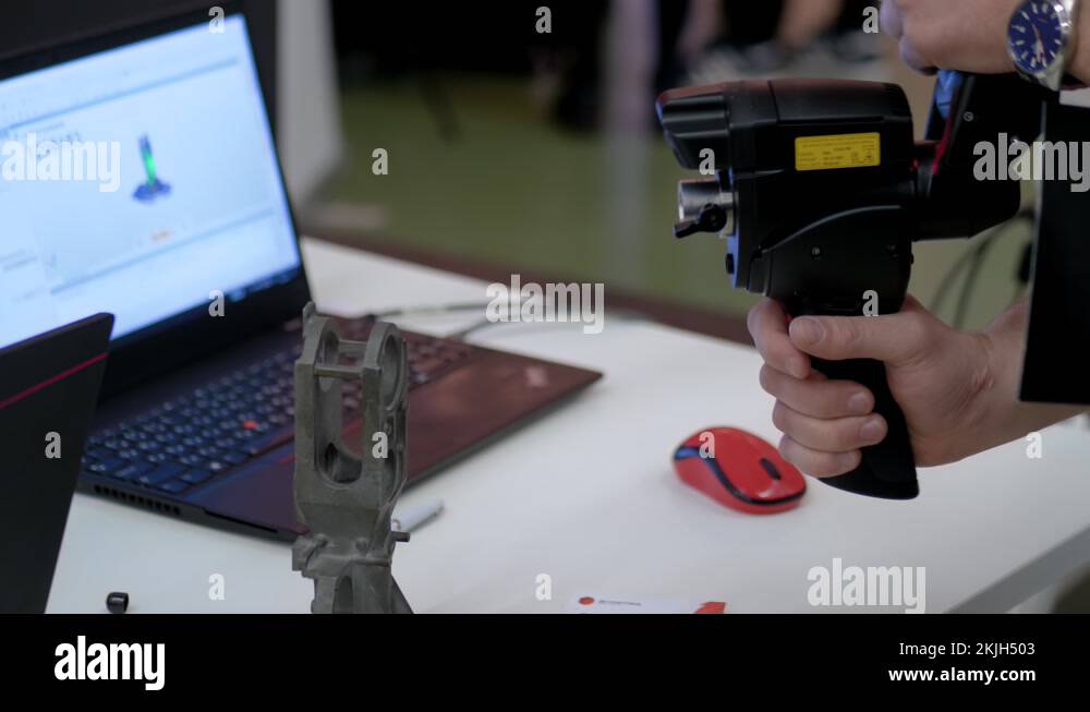 Man holding handheld 3d scanner for capturing object at 3d exhibition ...