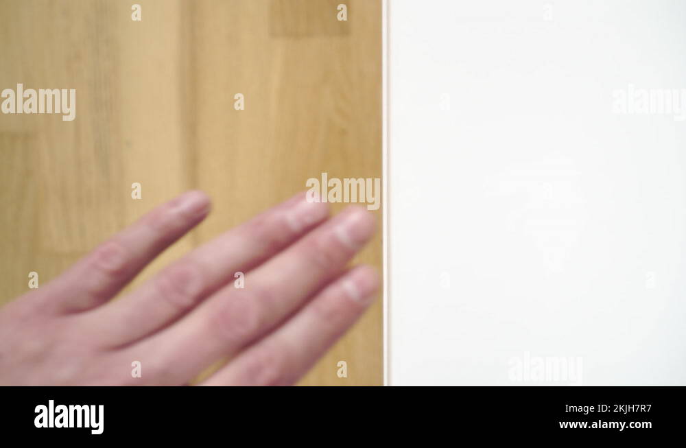 A man opens a shelf of a bedside table and grabs a medical surgical ...