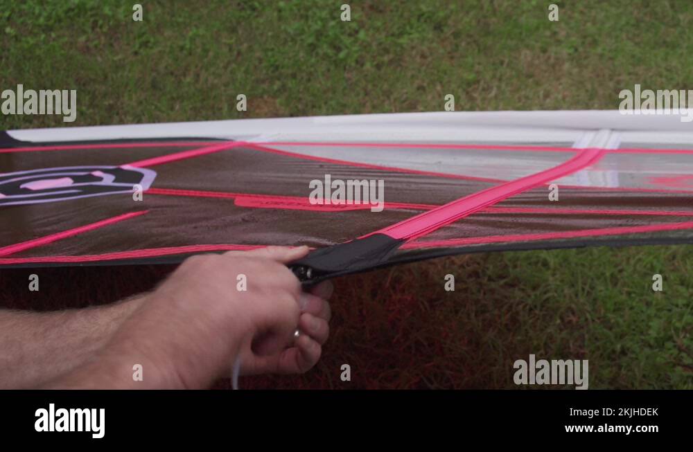 Assembling pink / red windsurf sail with allen key. Maui Hawaii Stock ...