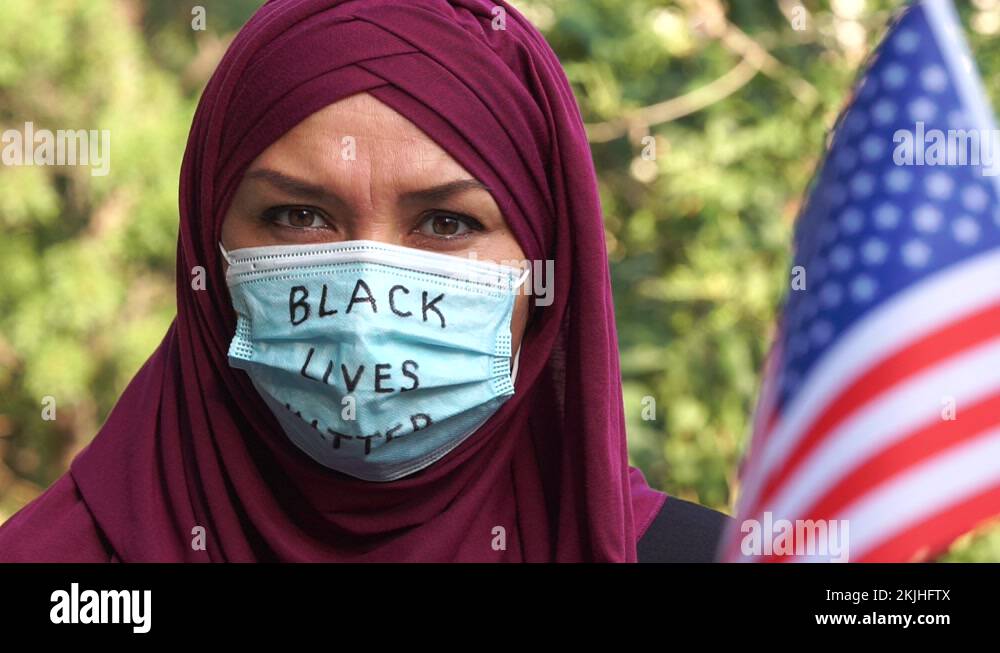 Black Lives Matter (BLM) movement in the United States. Muslim woman in ...