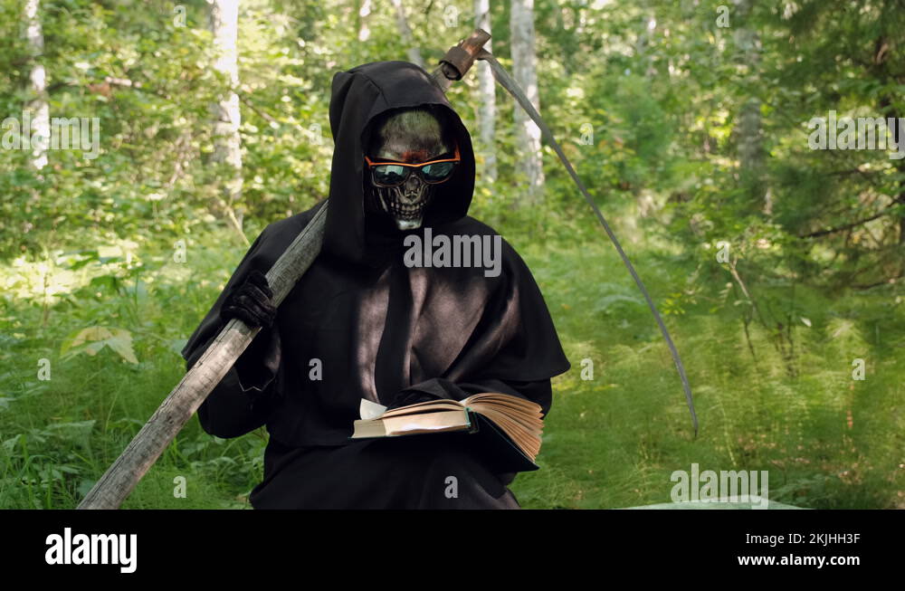 Grim Reaper with Scythe Reading a Book Outdoors Stock Video Footage - Alamy
