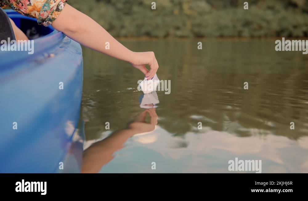 Origami Ship In Water.Paper Boat On River.Woman Hand With Paper Boat ...