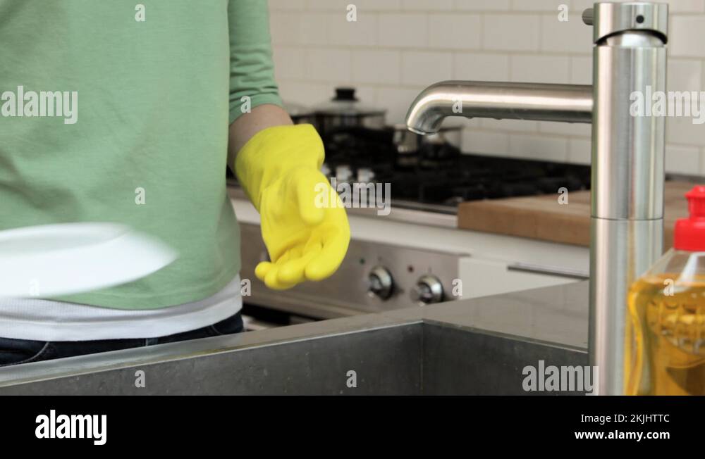 Woman finishing washing up and removing rubber gloves Stock Video ...