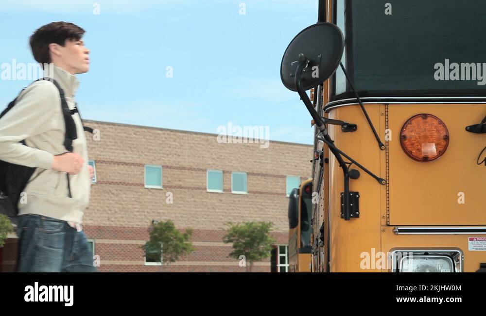 High school student waiting outside on school bus Stock Video Footage ...