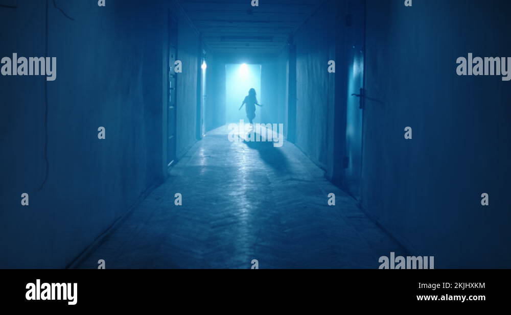 Little girl in white dress looking like a ghost carelessly running down ...