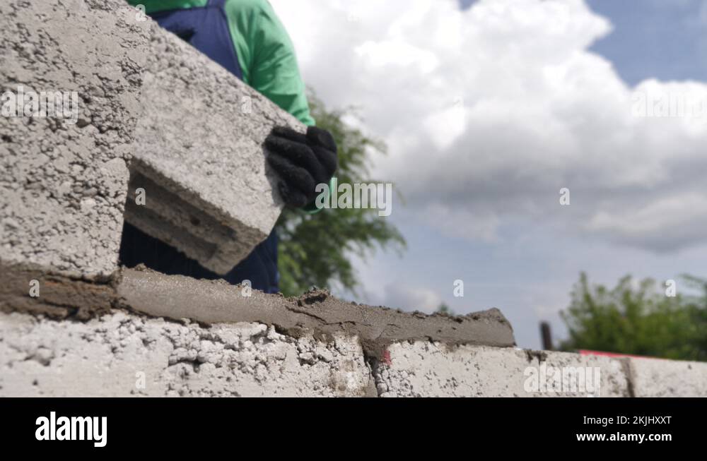 Bricklayer's Hands Puts the Brick. Mason Installation of Concrete ...