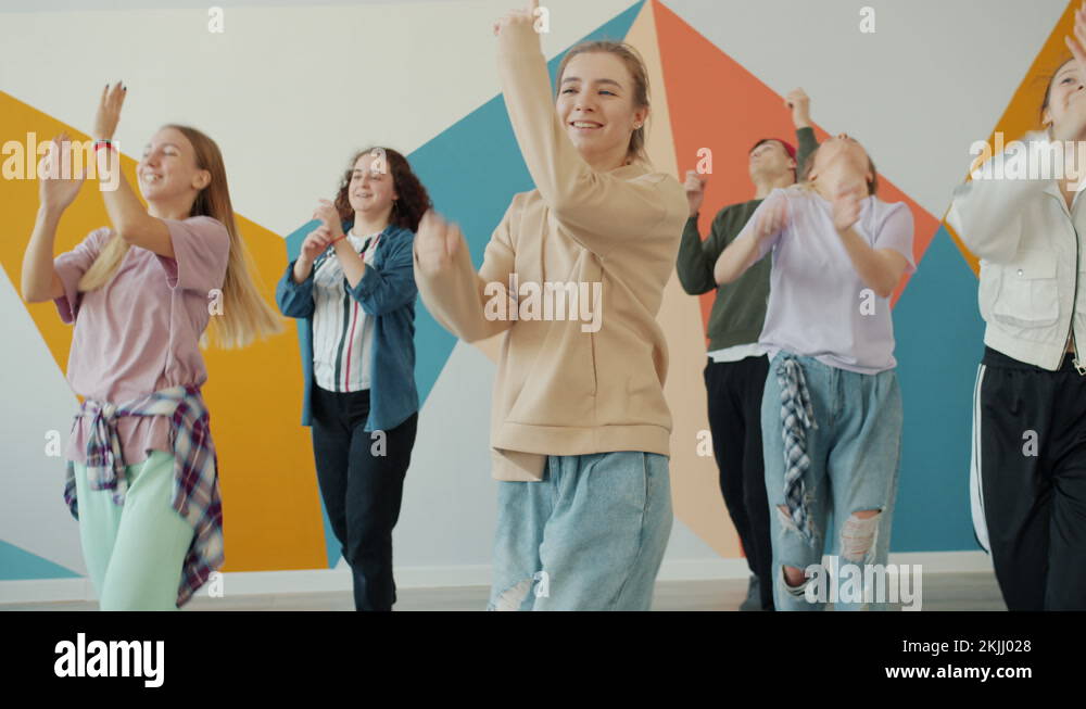 Young performers training practicing moves looking at teacher and ...