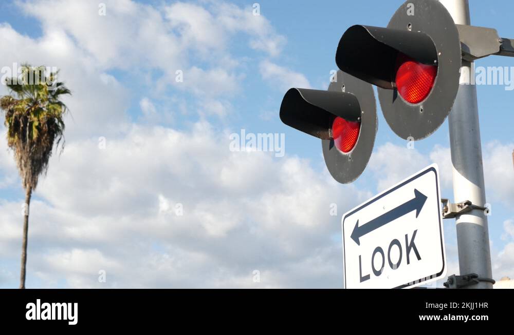 Level crossing warning signal in USA. Crossbuck notice and red traffic ...