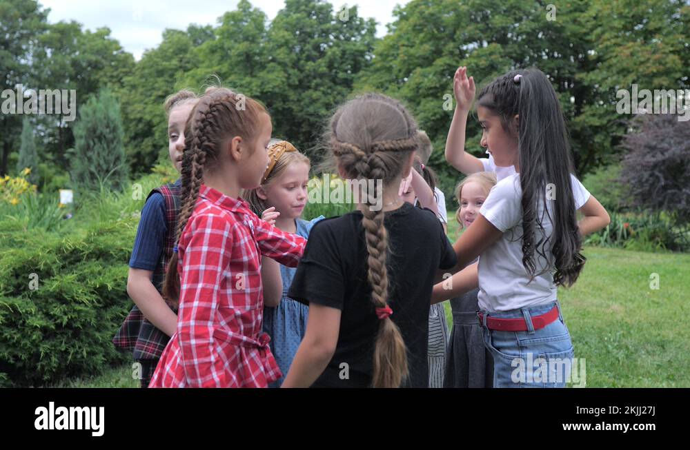 Kids team building. A group of happy children holding hands together ...