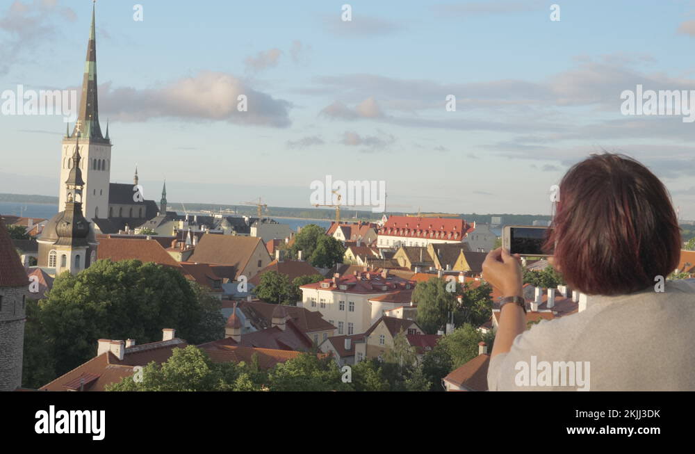 The lady taking photos of the view of the Tallinn Old Town in Estonia ...