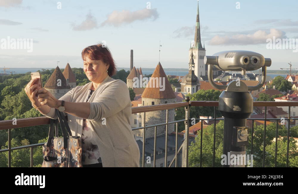 A look of the lady taking selfies on the Tallinn Old Town in Estonia ...