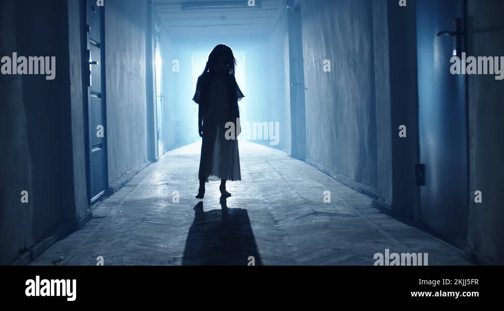Little girl in white dress looking like a ghost slowly creeping down ...