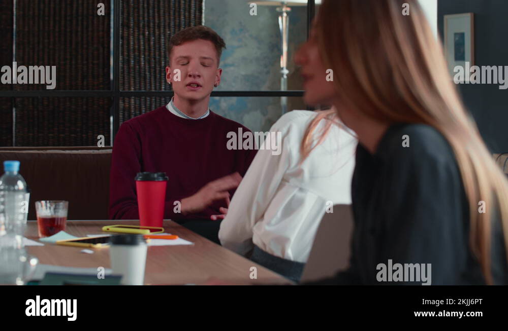 Busy modern office background. Happy confident gen-z male business ...