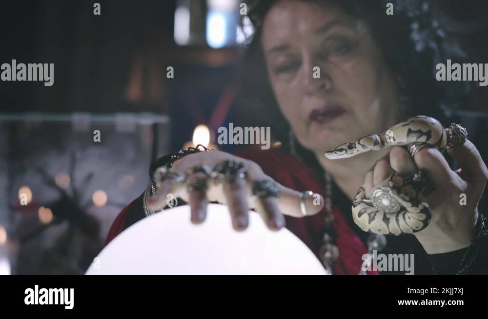 Woman fortune teller using snake and crystal ball divining future Stock ...