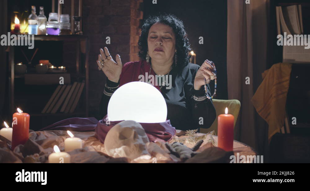 Old woman seer meditating and predicting future with crystal ball Stock ...