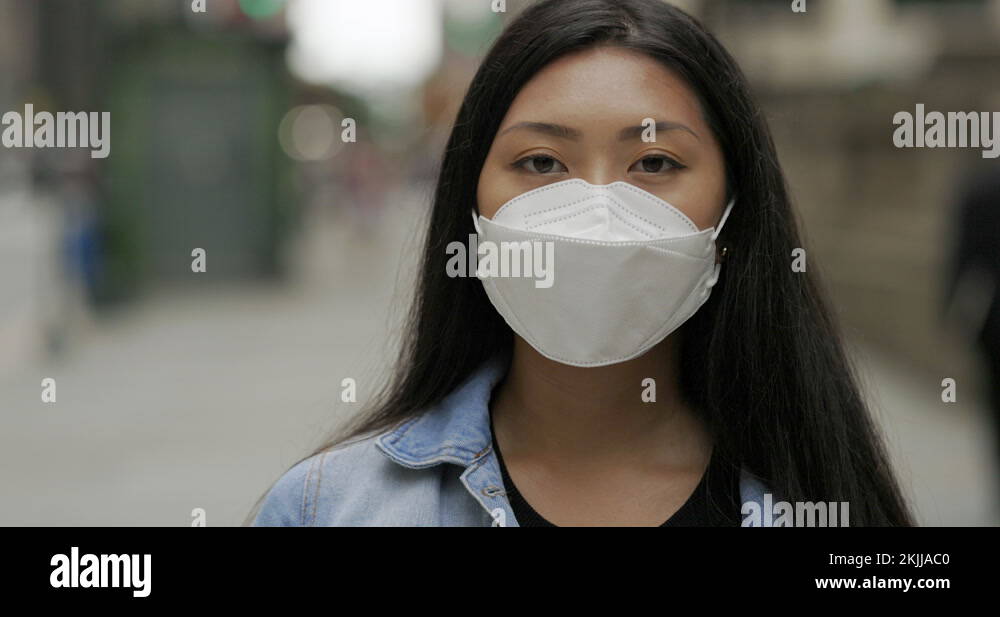 Young Asian woman wearing a mask face portrait serious to smile Stock ...