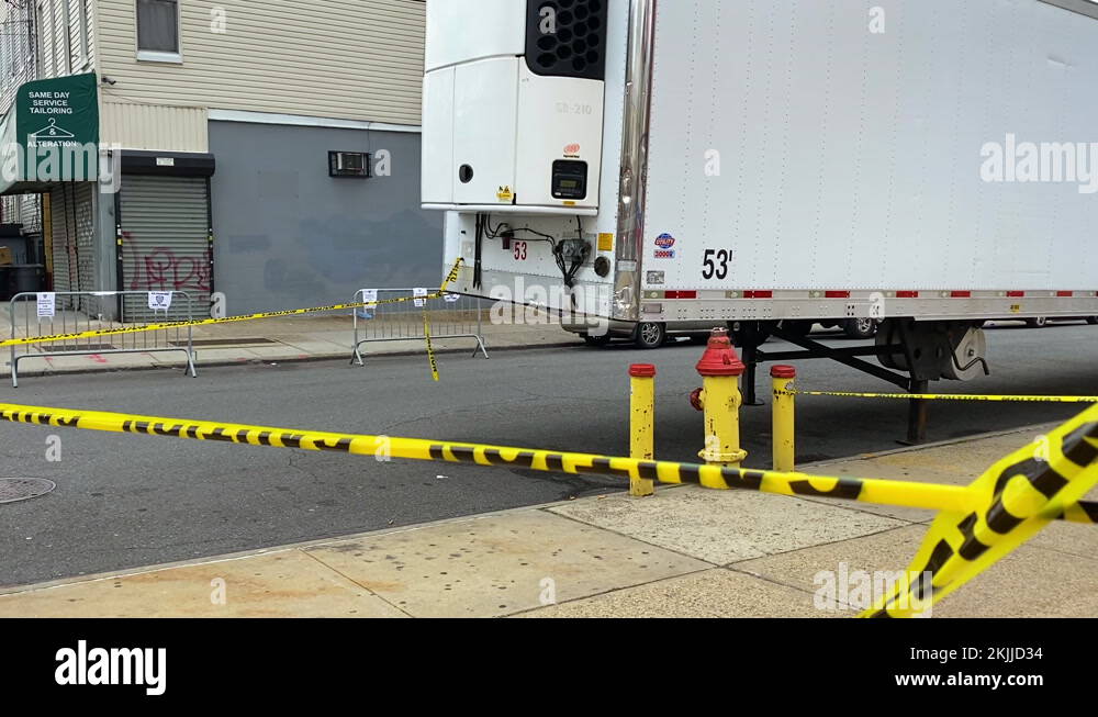 Ambulance passing temporary morgue set up in refrigerated trailer Stock ...