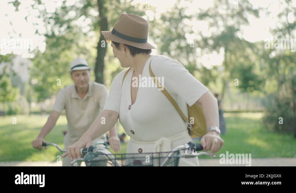 Rack focus changes from charming smiling mid-adult woman looking back ...