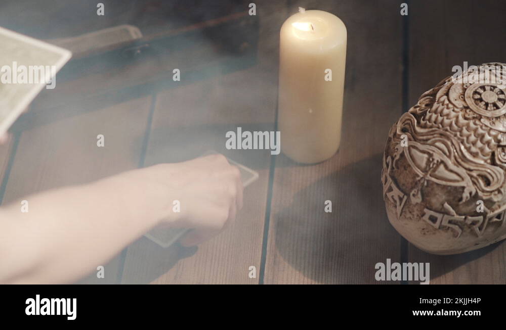 Scene of fortune-teller placing tarot cards on table. Mystic ritual of ...