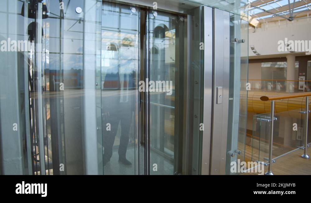 Tired overworked employee walking out of elevator and going home after ...