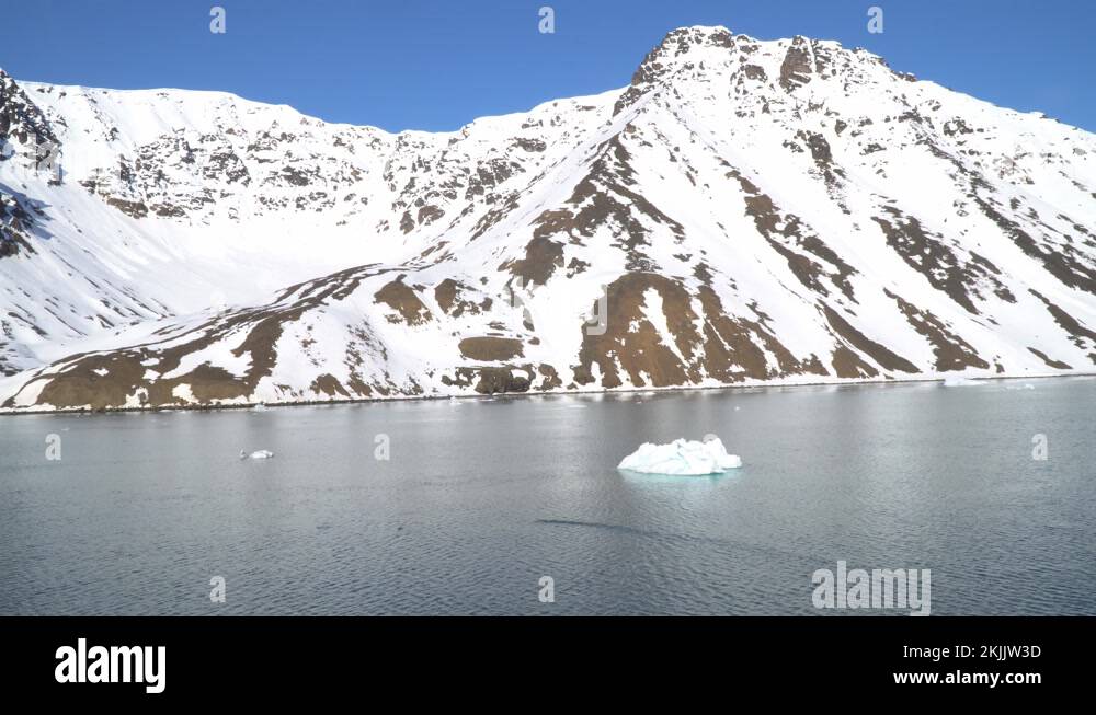Arctic sailing among glaciers and floating ice blocks, in frozen sea ...