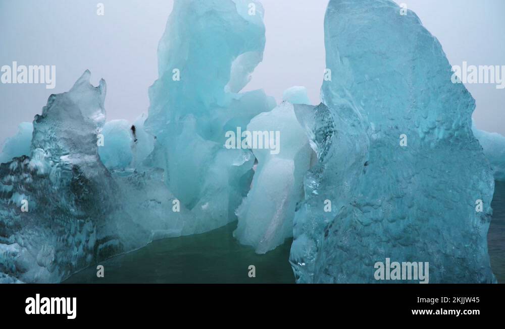 Arctic sailing among glaciers and floating ice blocks, in frozen sea ...