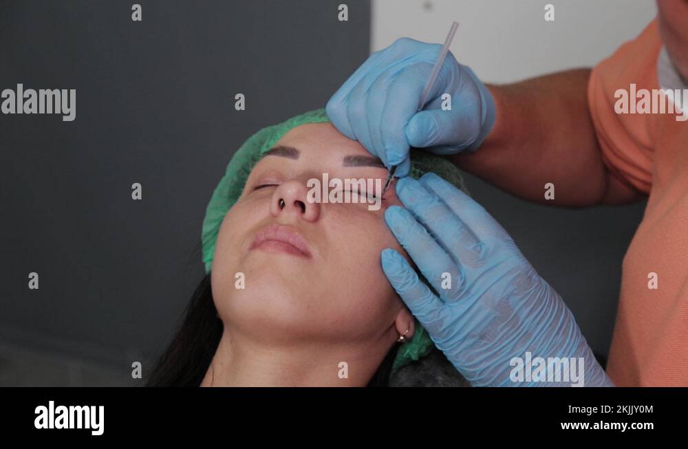 A pretty woman is marked out with permanent makeup areas Stock Video ...