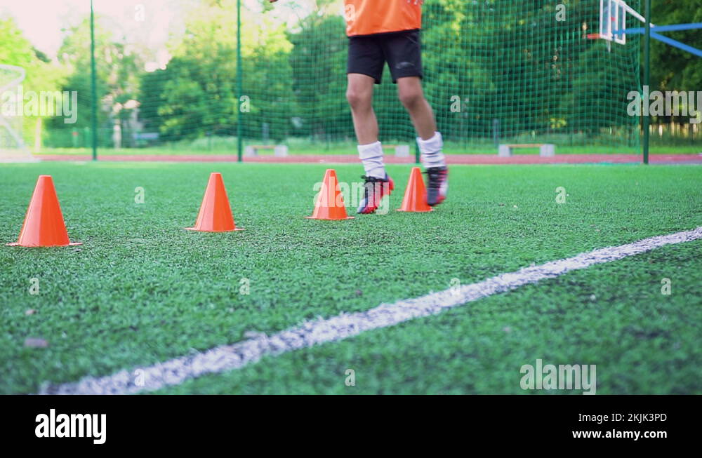 Purposeful sporty teen boy doing running exercises with racks that are ...