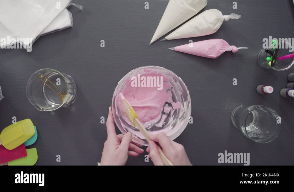 Mixing in food coloring into the royal icing to decorate sugar cookies ...