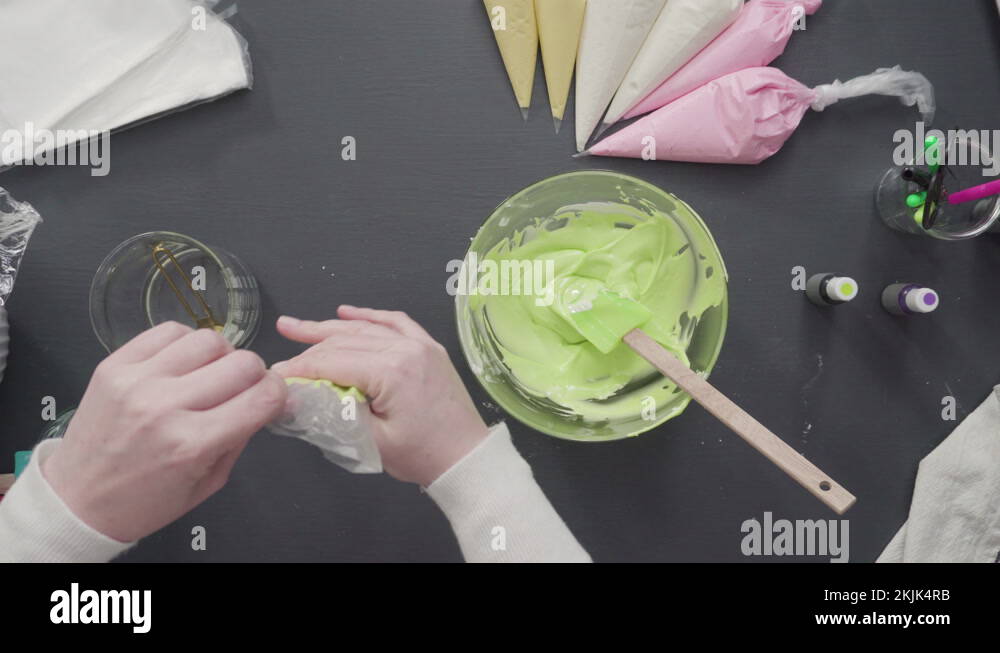 Mixing in food coloring into the royal icing to decorate sugar cookies ...