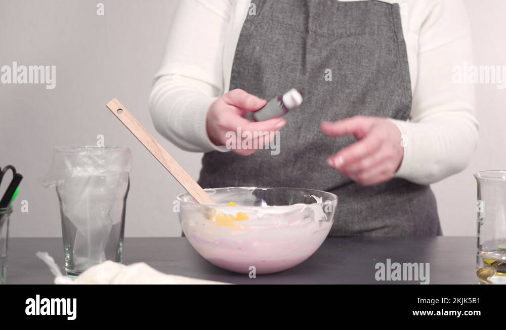 Mixing in food coloring into the royal icing to decorate sugar cookies ...