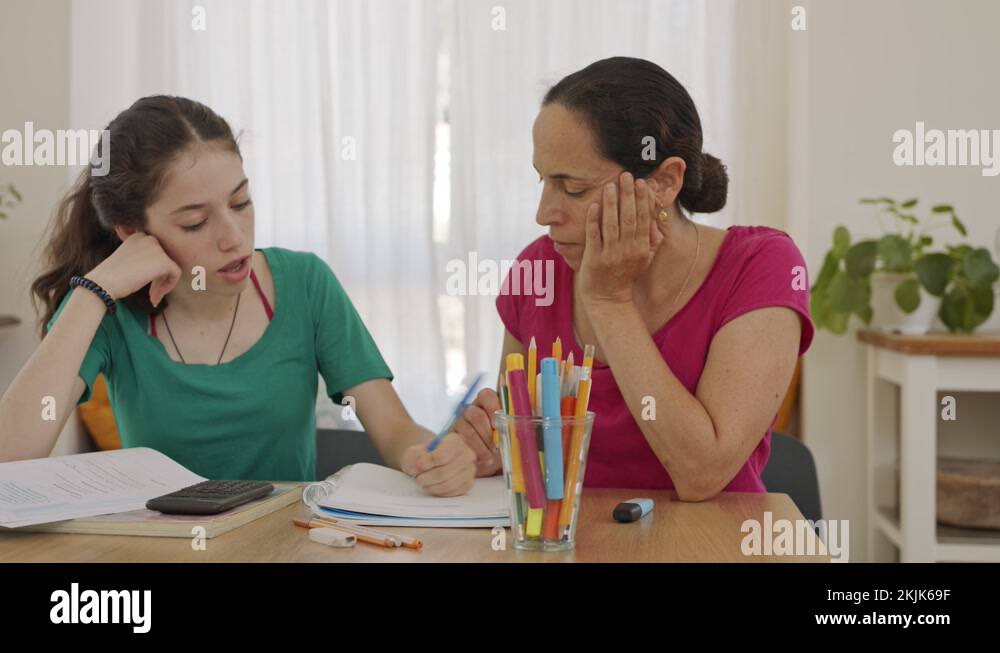 Mother helping her teenage daughter prepare homework Stock Video ...