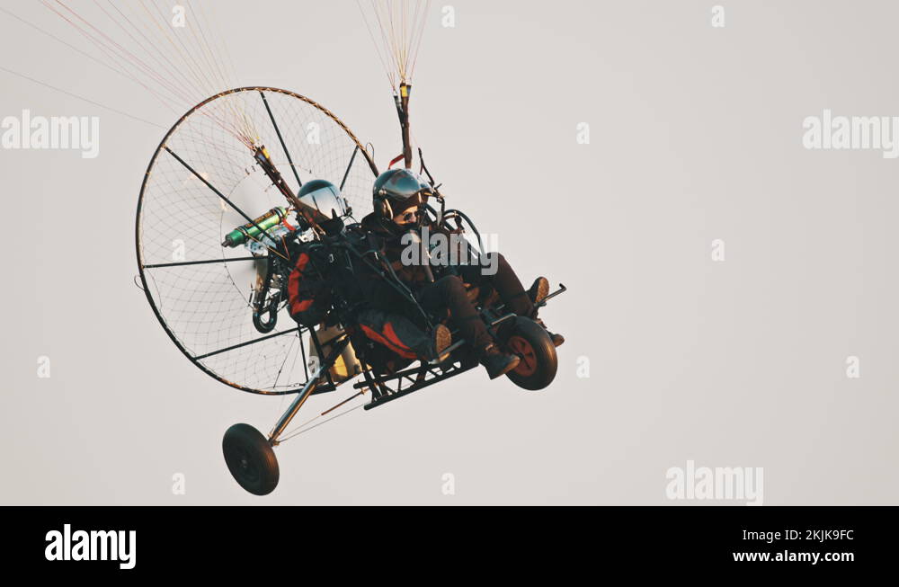 Tandem Paramotor Gliding - two men flying and gliding in the air Stock ...